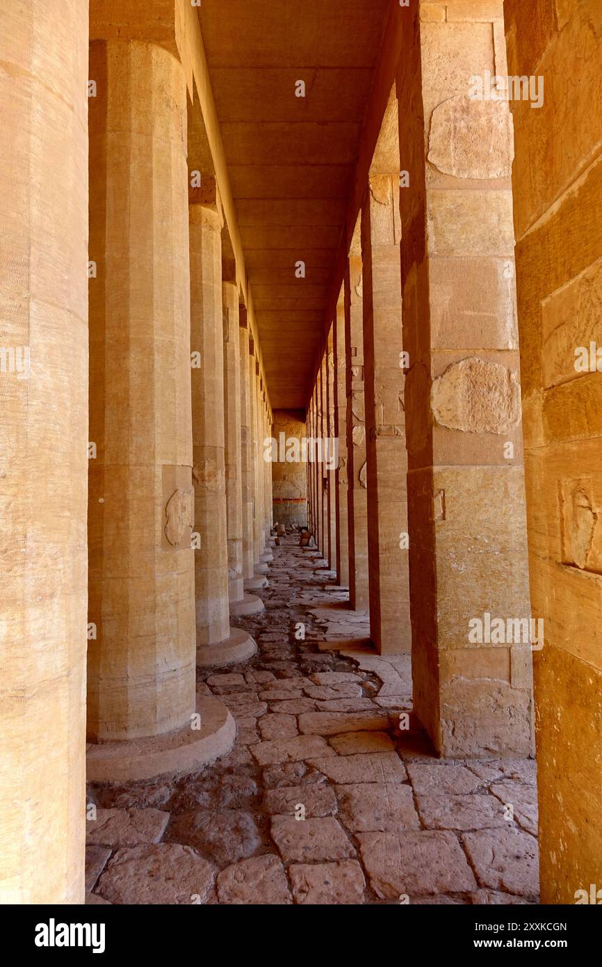 Visitors walk through the ancient colonnade of Hatshepsut's Mortuary ...