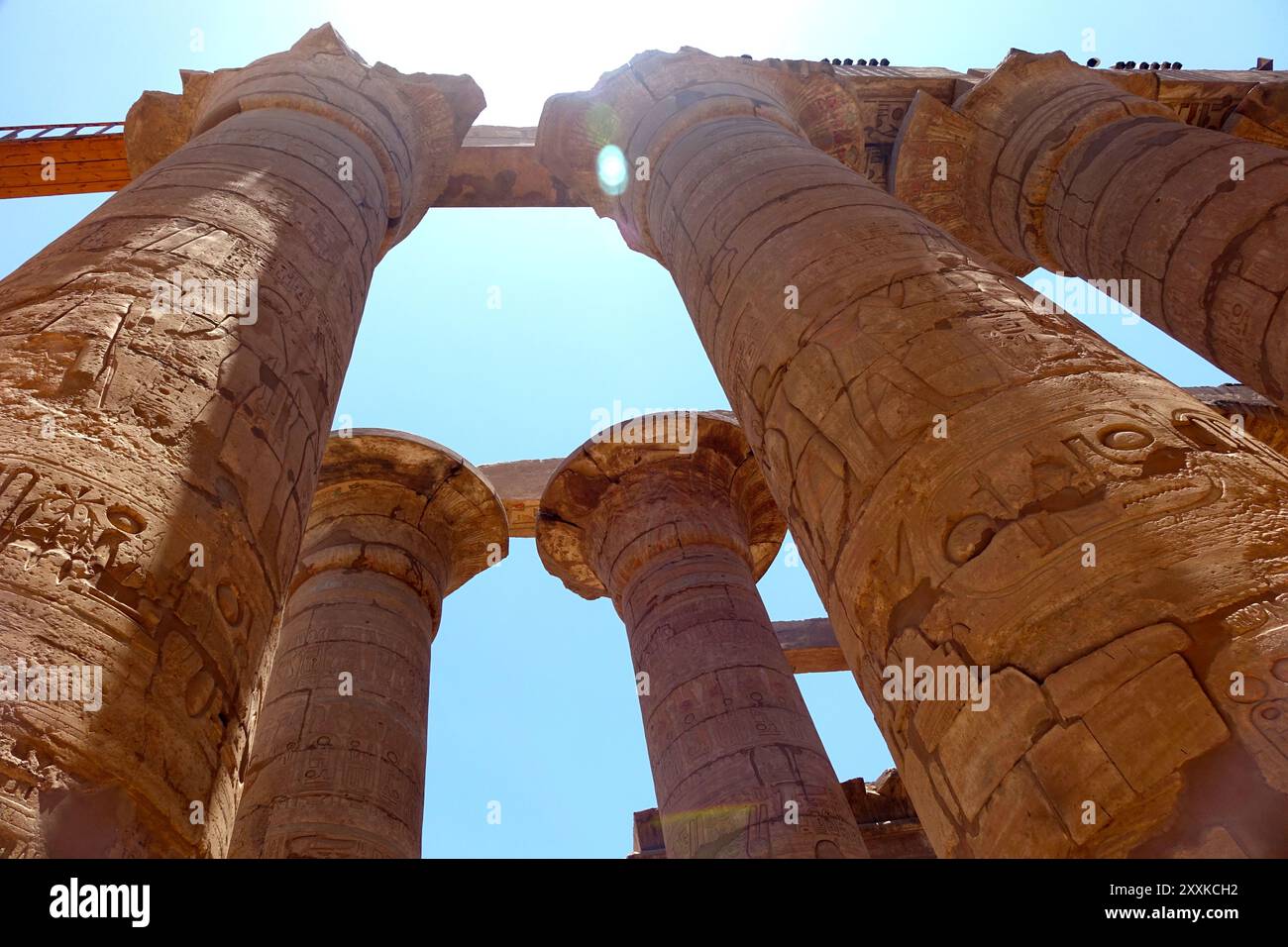 Visitors admire the towering columns of the Karnak temple complex ...