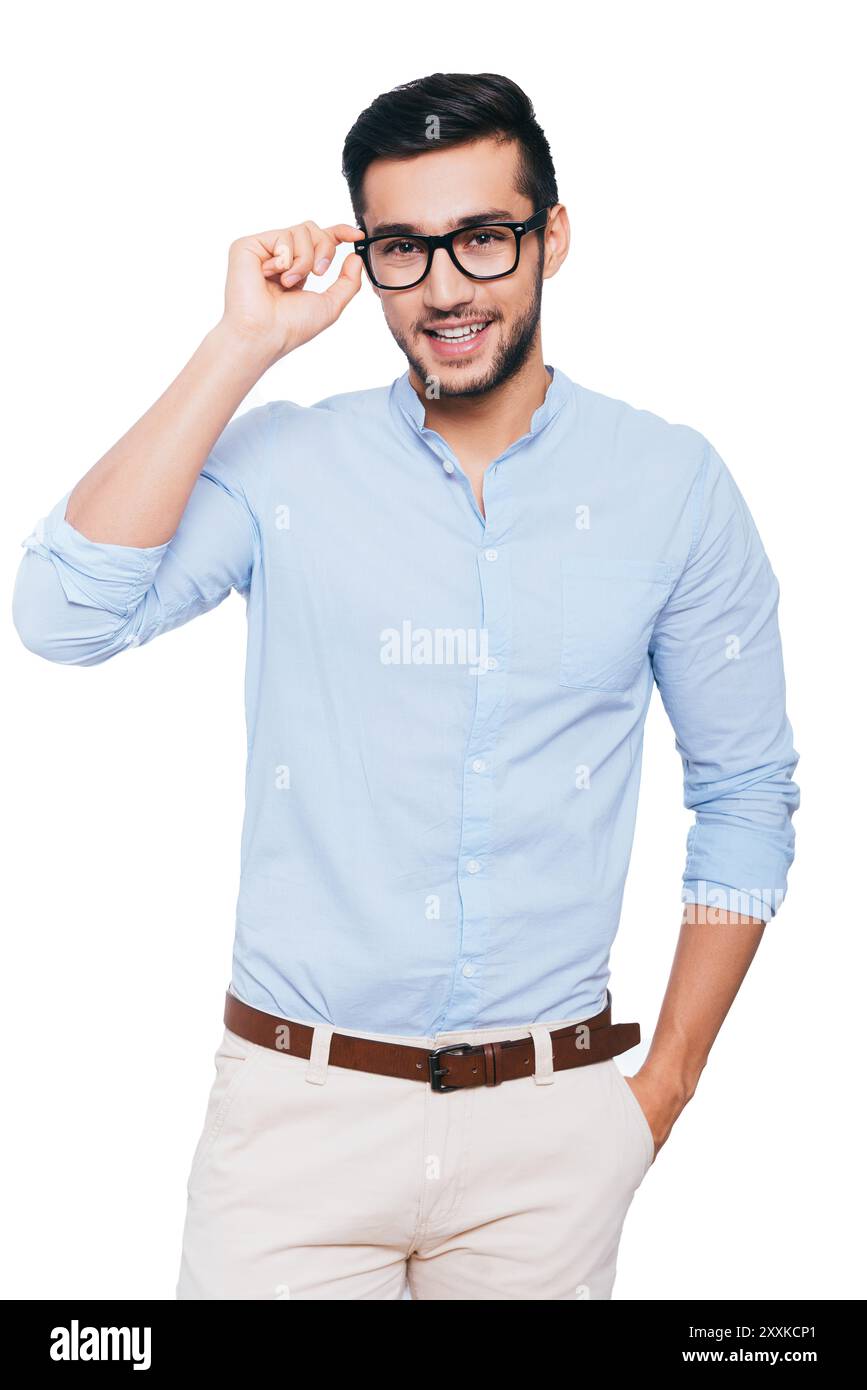Charming handsome. Confident young Indian man adjusting his eyeglasses ...