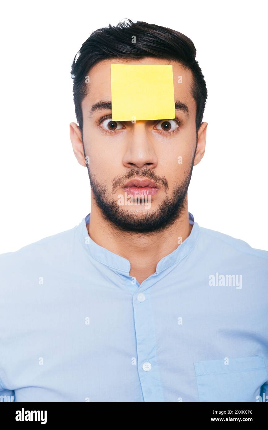 What was that? Shocked young Indian man with adhesive note on his ...