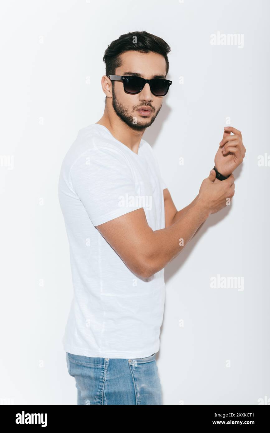 Confident in his style. Side view of handsome young Indian man ...