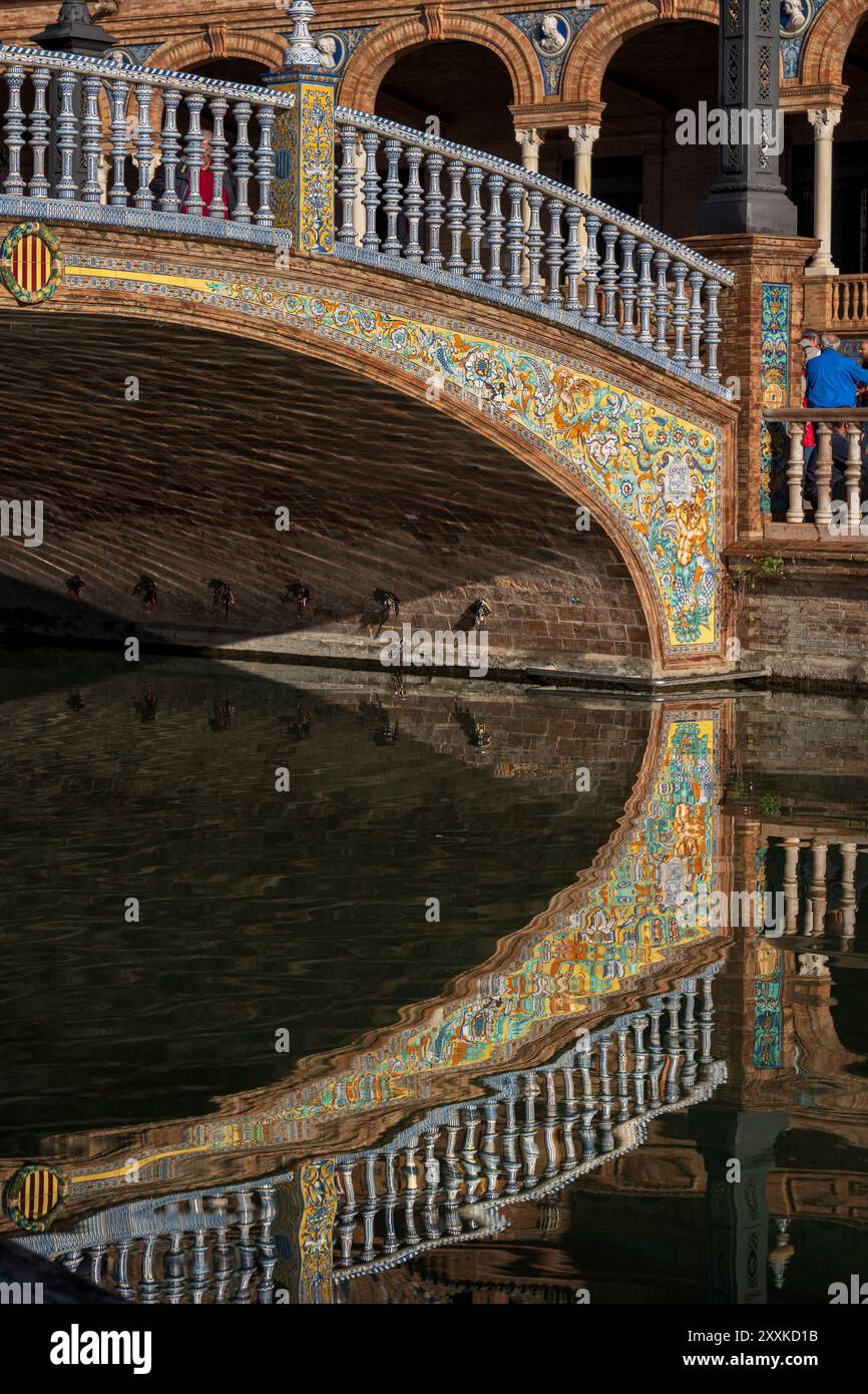 Canal bridge decorated with azulejo tiles and reflection in water at ...