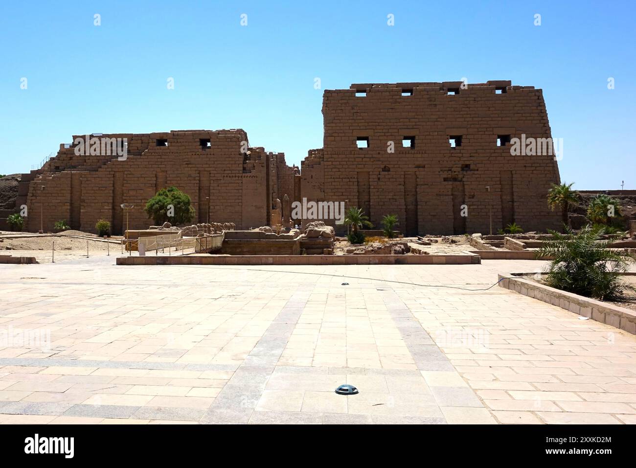 Visitors wander through the expansive ruins of the Karnak temple ...