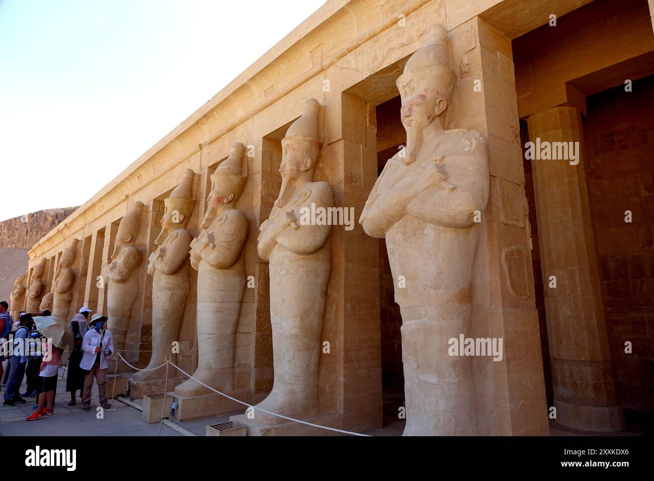 Visitors admire the impressive ancient statues at the Mortuary Temple ...