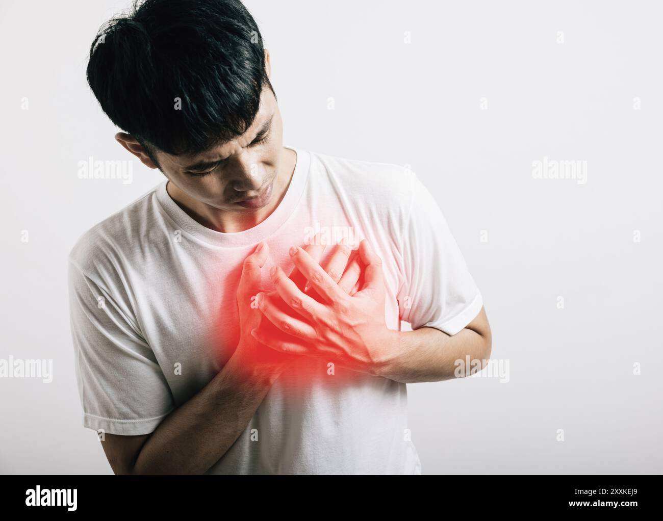 Portrait Asian young man holding his arms around his chest suffering ...