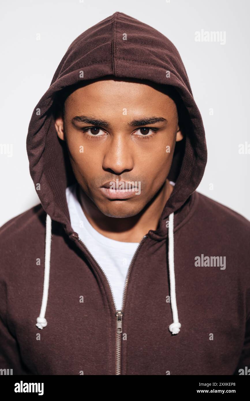 Feeling energy inside. Confident young African man in hooded shirt ...