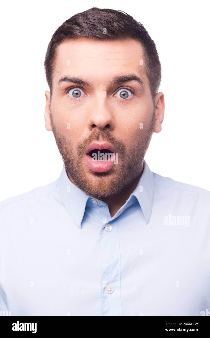 Shocking news. Portrait of surprised young man in shirt staring at ...