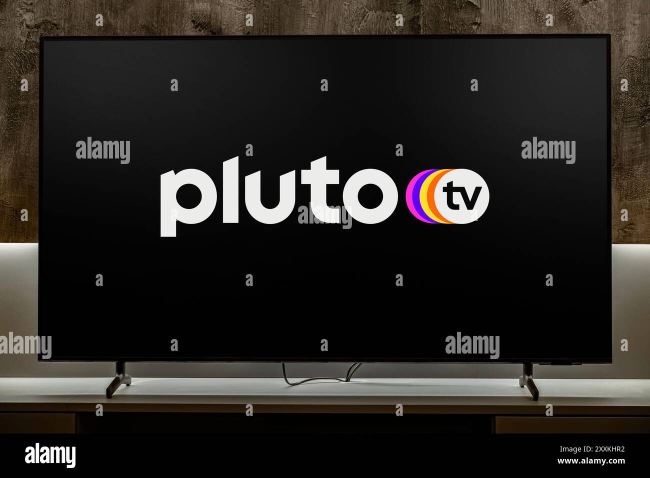 POZNAN, POL - DEC 19, 2023: Flat-screen TV set displaying logo of Pluto ...