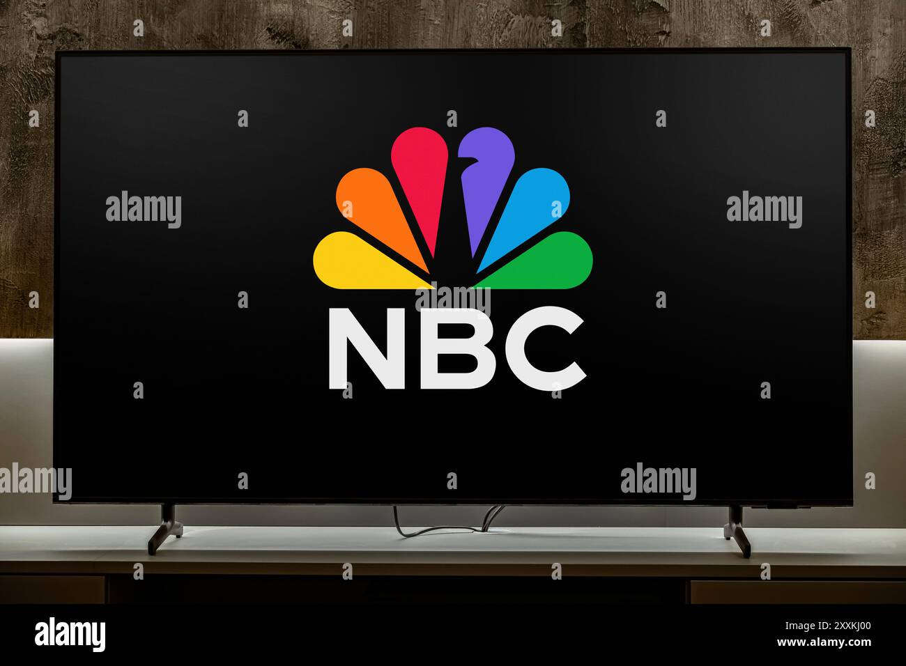 POZNAN, POL - MAR 01, 2024: Flat-screen TV set displaying logo of NBC ...