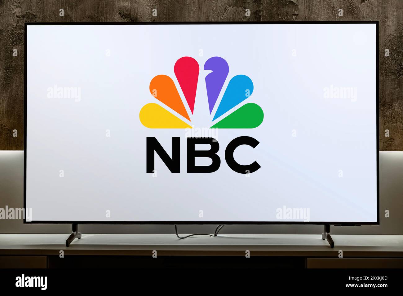 POZNAN, POL - MAR 01, 2024: Flat-screen TV set displaying logo of NBC ...