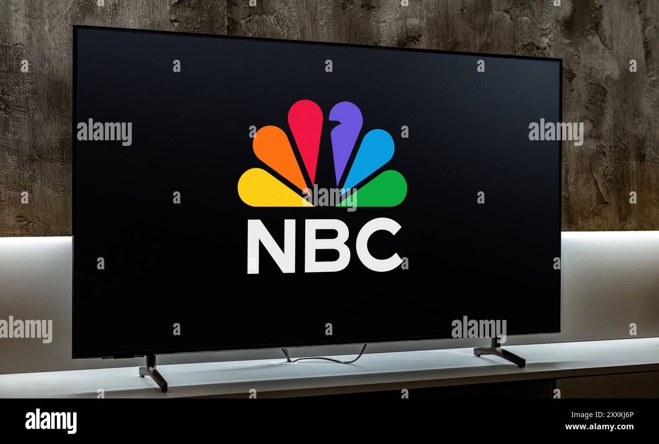 POZNAN, POL - MAR 01, 2024: Flat-screen TV set displaying logo of NBC ...
