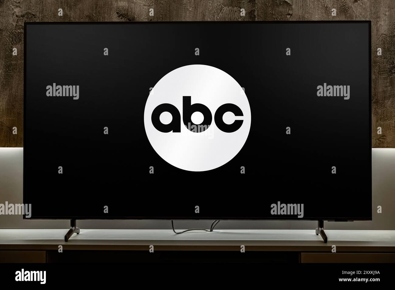 POZNAN, POL - MAR 01, 2024: Flat-screen TV set displaying logo of the American Broadcasting ...