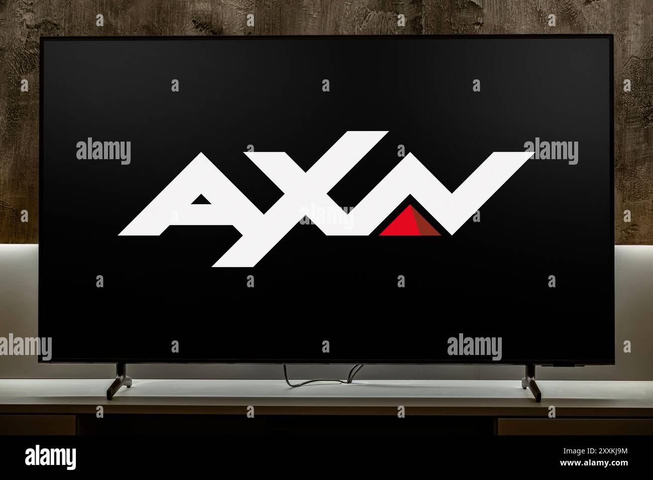 POZNAN, POL - APR 10, 2024: Flat-screen TV set displaying logo of AXN ...