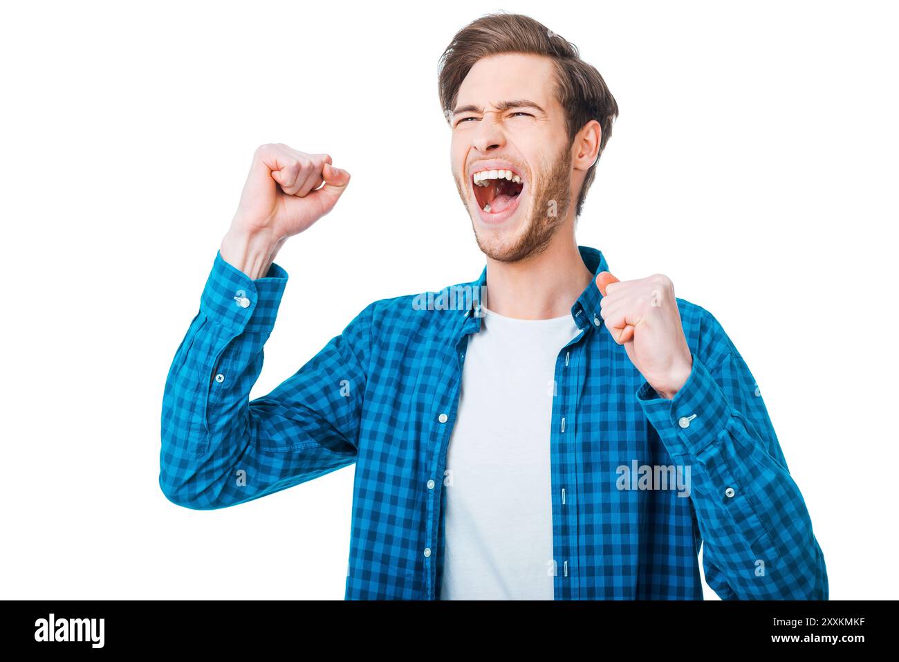 The win is in my pocket. Excited young man keeping arms raised and ...