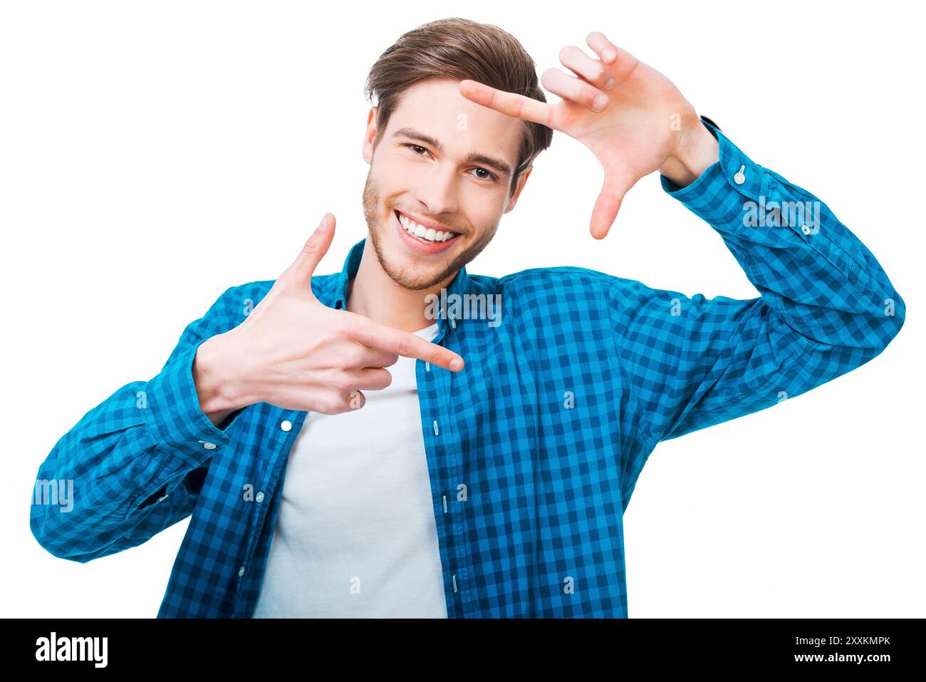 Finger frame. Handsome young man gesturing a finger frame and looking ...