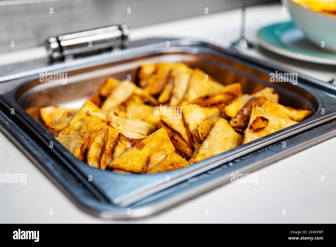 Lots of fried samosas in a metal tray Stock Photo - Alamy
