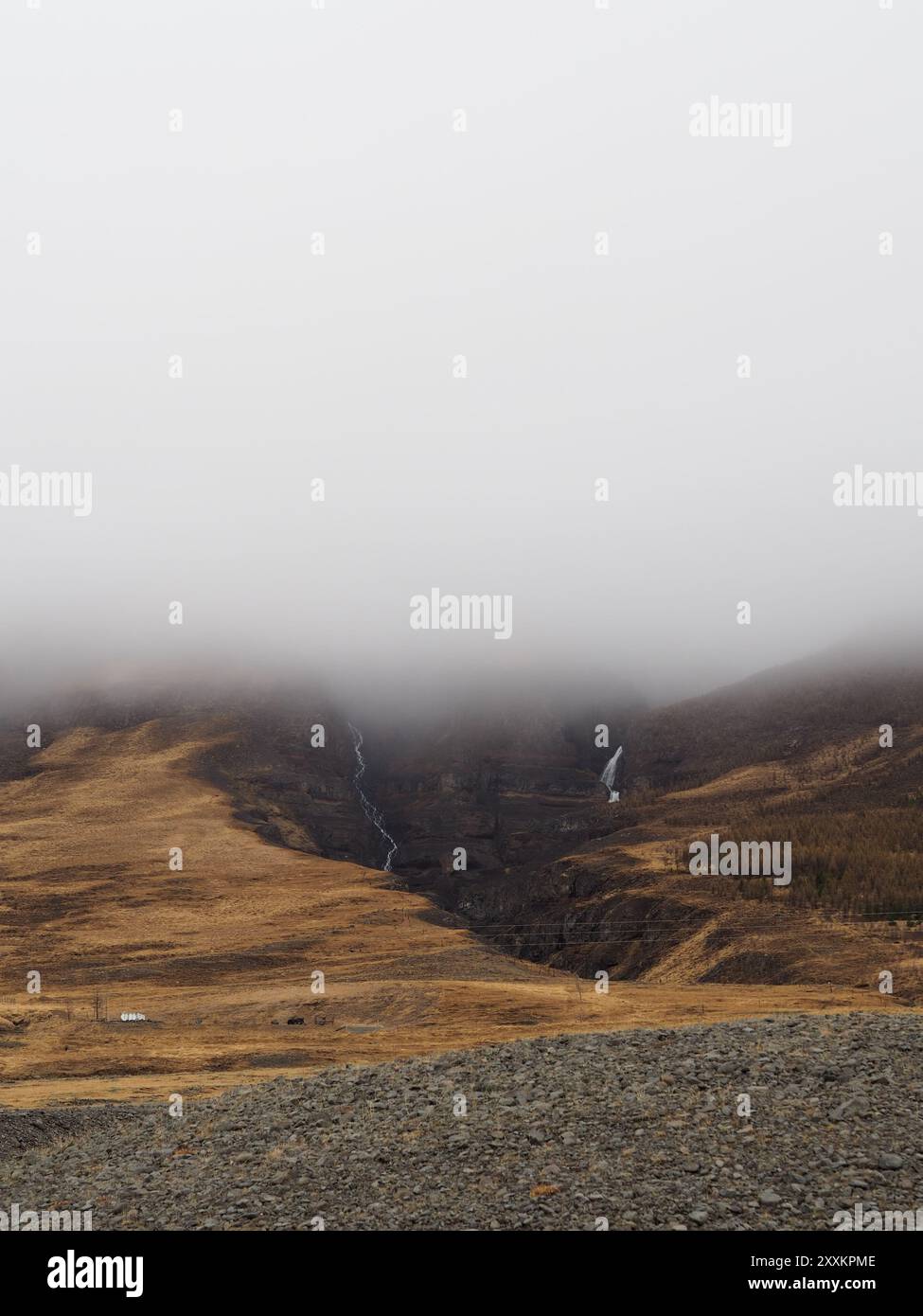 An ethereal landscape shrouded in mist reveals distant waterfalls ...