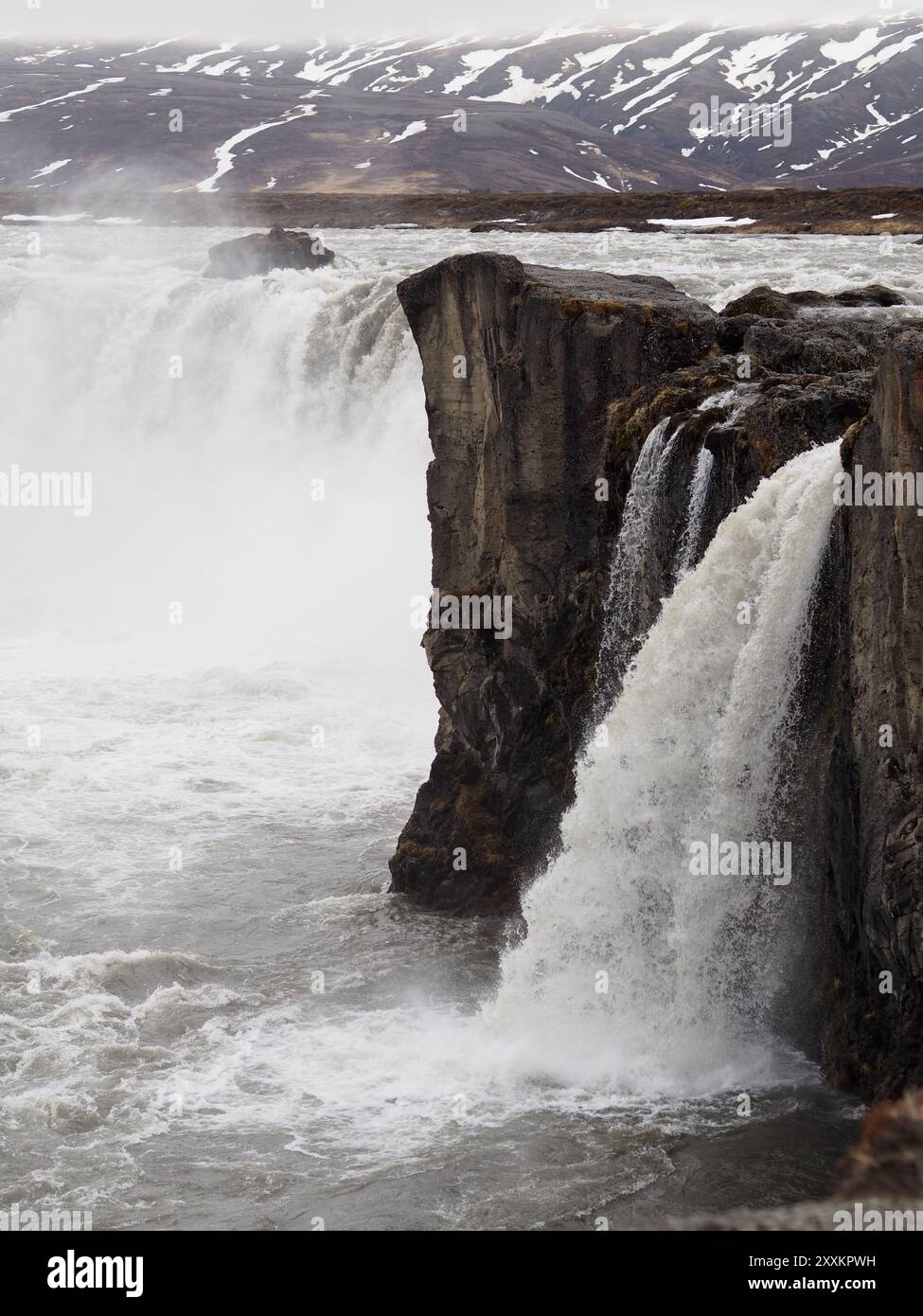 A majestic waterfall plunging over rugged cliffs in a powerful and ...