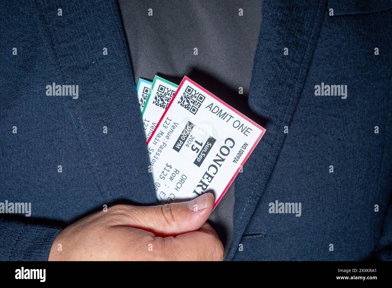 A hand extracts three concert tickets from a pocket, a common tactic ...