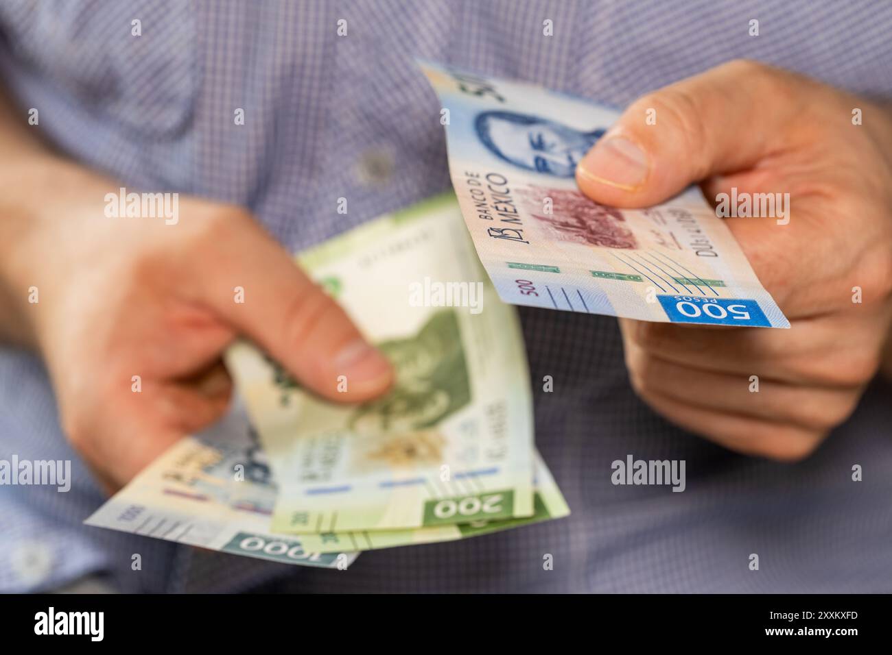 Mexico money. Man giving someone a 500 peso bill, Business concept ...