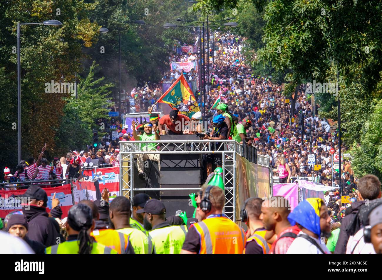 London, UK, 25th August, 2024. Huge crowds following parade floats were ...