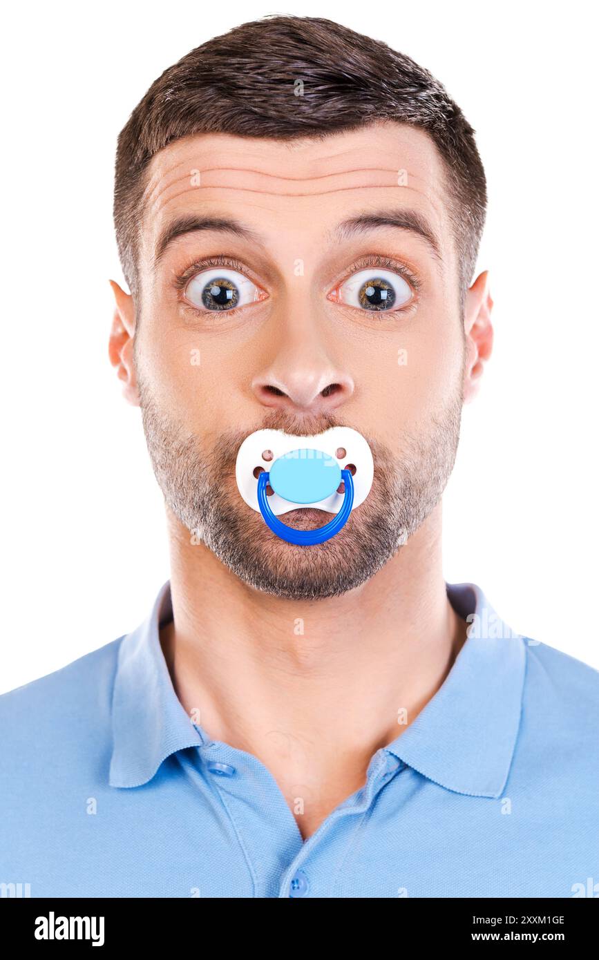 Like a baby. Funny young man with big eyes and pacifier in his mouth ...
