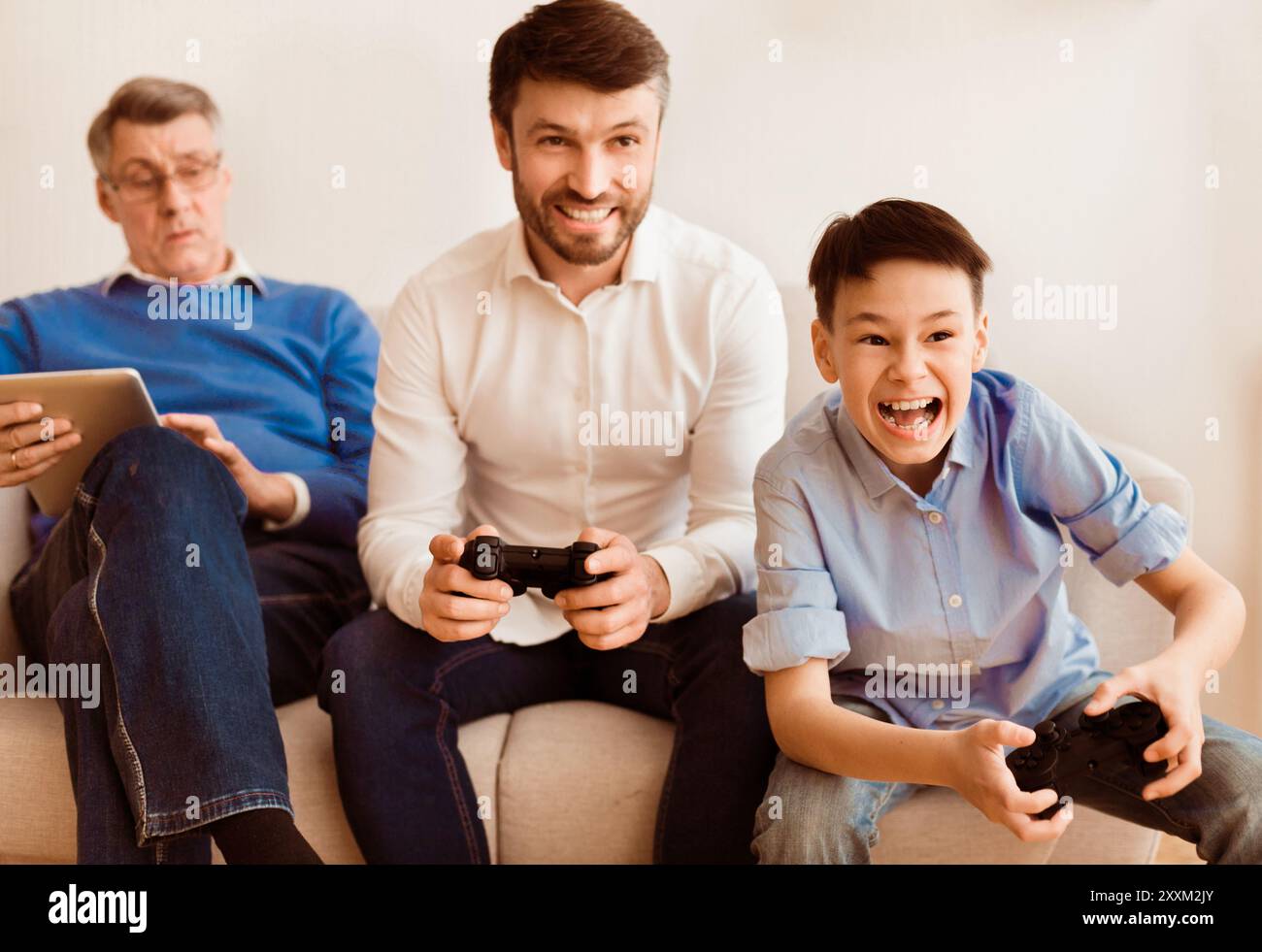 Grandfather and son playing video hi-res stock photography and images ...