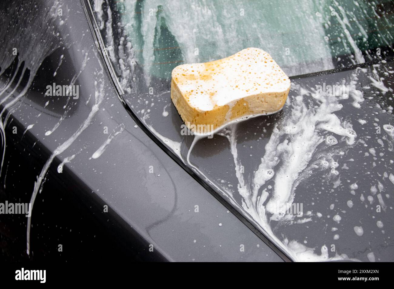 Car washing. Cleaning automobile with foam.Vehicle covered with foam ...