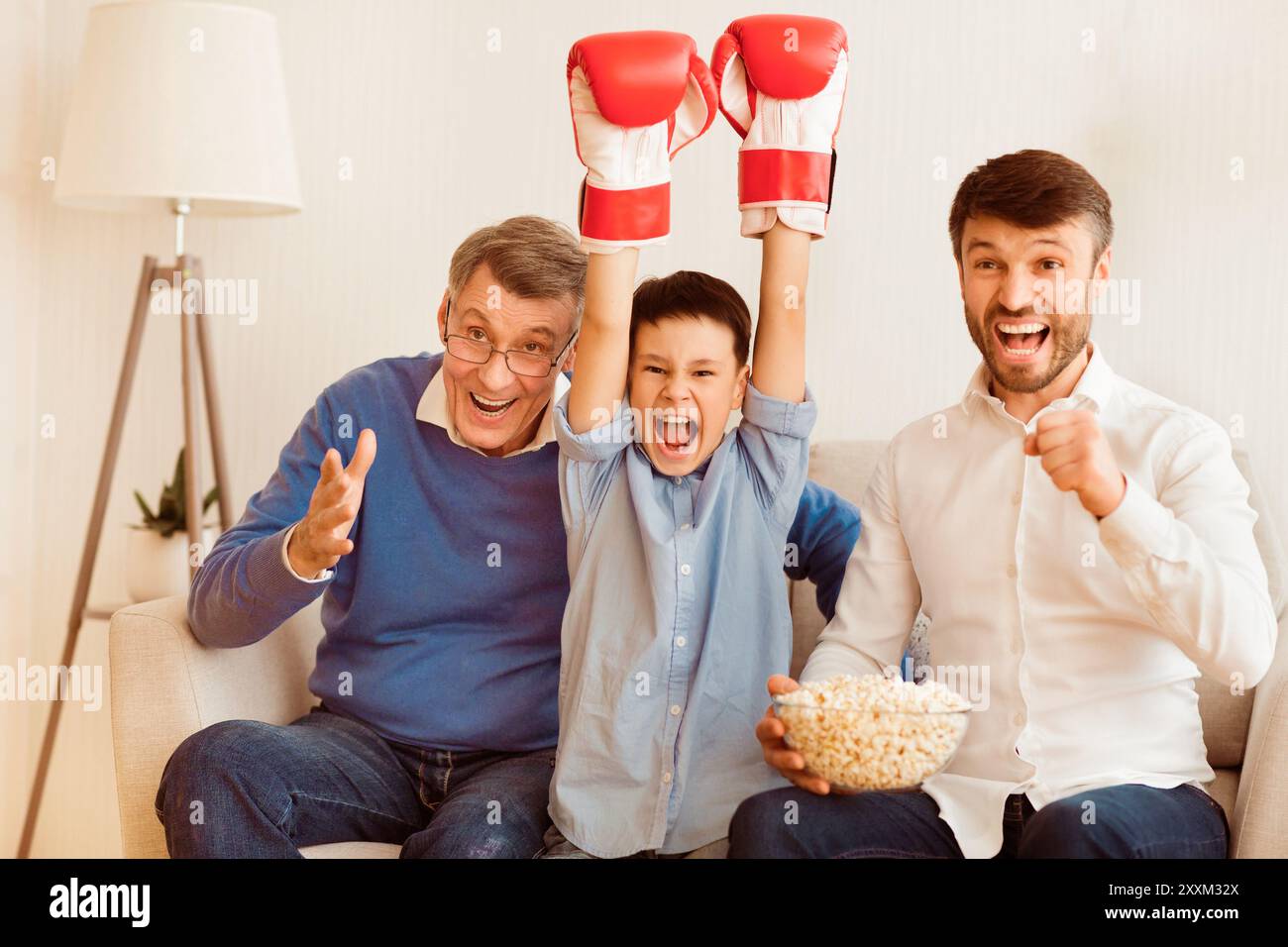 Boy, Father And Grandfather Watching Boxing Match On TV Indoor Stock ...