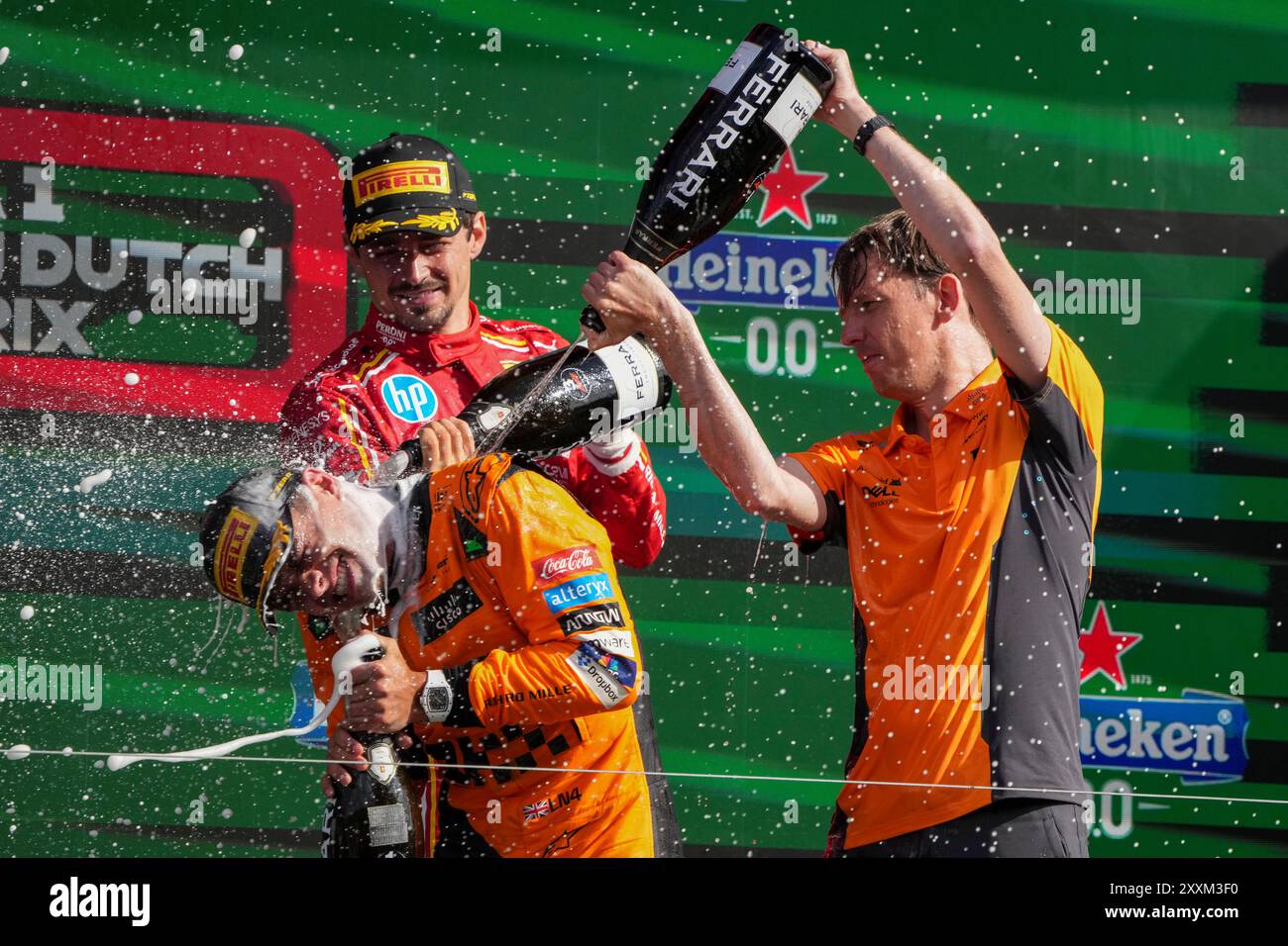 McLaren driver Lando Norris of Britain is sprayed with champagne as he ...