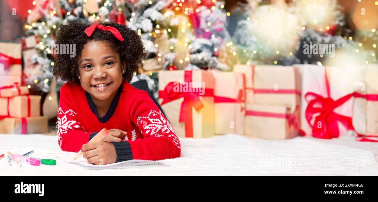 Adorable little black girl writing wish list of presents Stock Photo ...