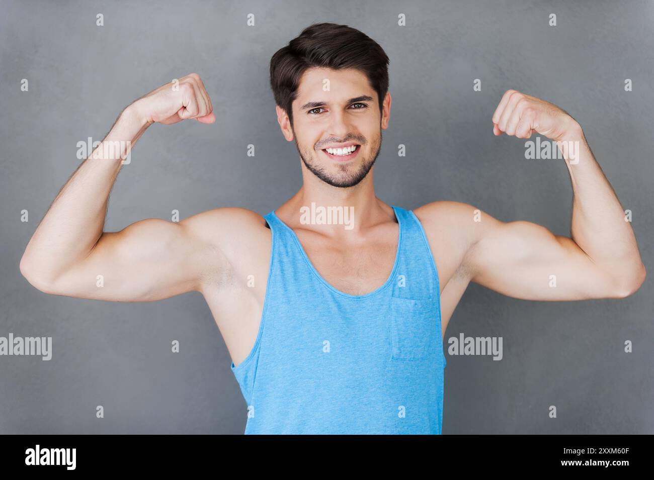 True masculinity. Handsome young muscular man showing his perfect ...