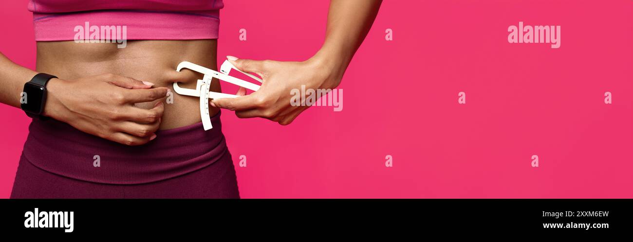 Woman measuring her body fat with body fat caliper Stock Photo - Alamy