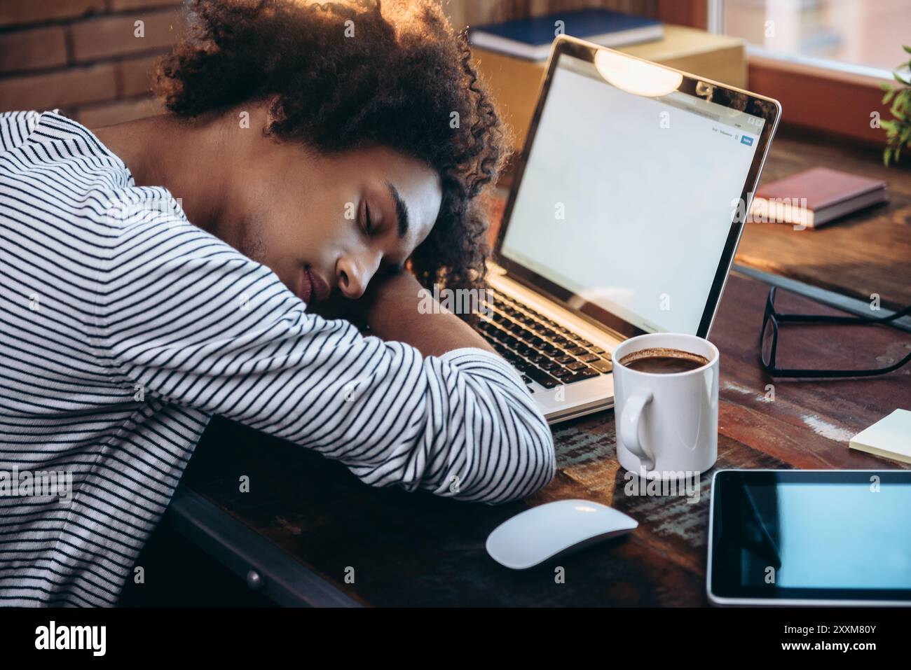 Quick nap. Side view of young African man sleeping on laptop with eyes ...