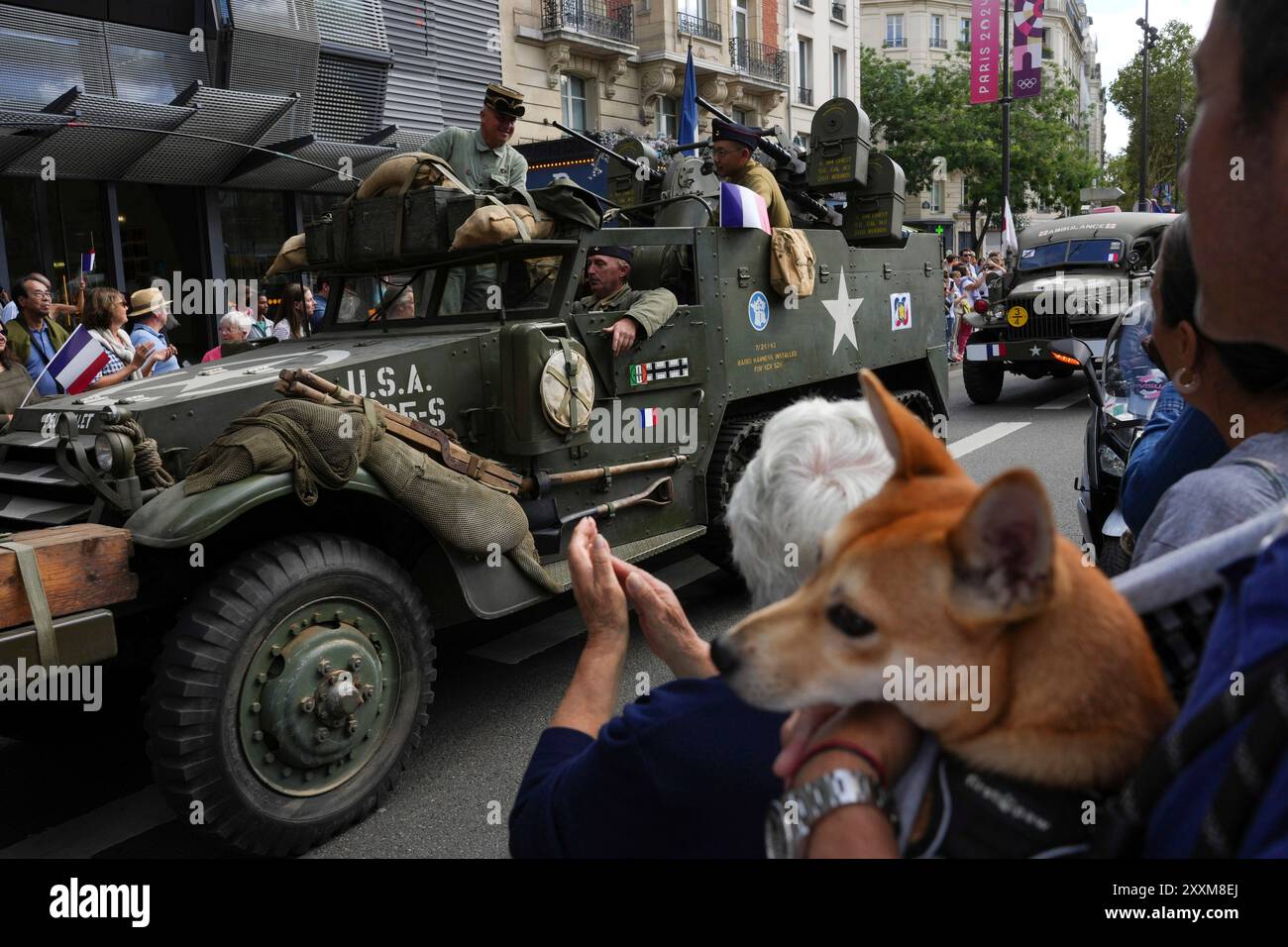 Reenactors parade in vintage military cars as they celebrate the ...