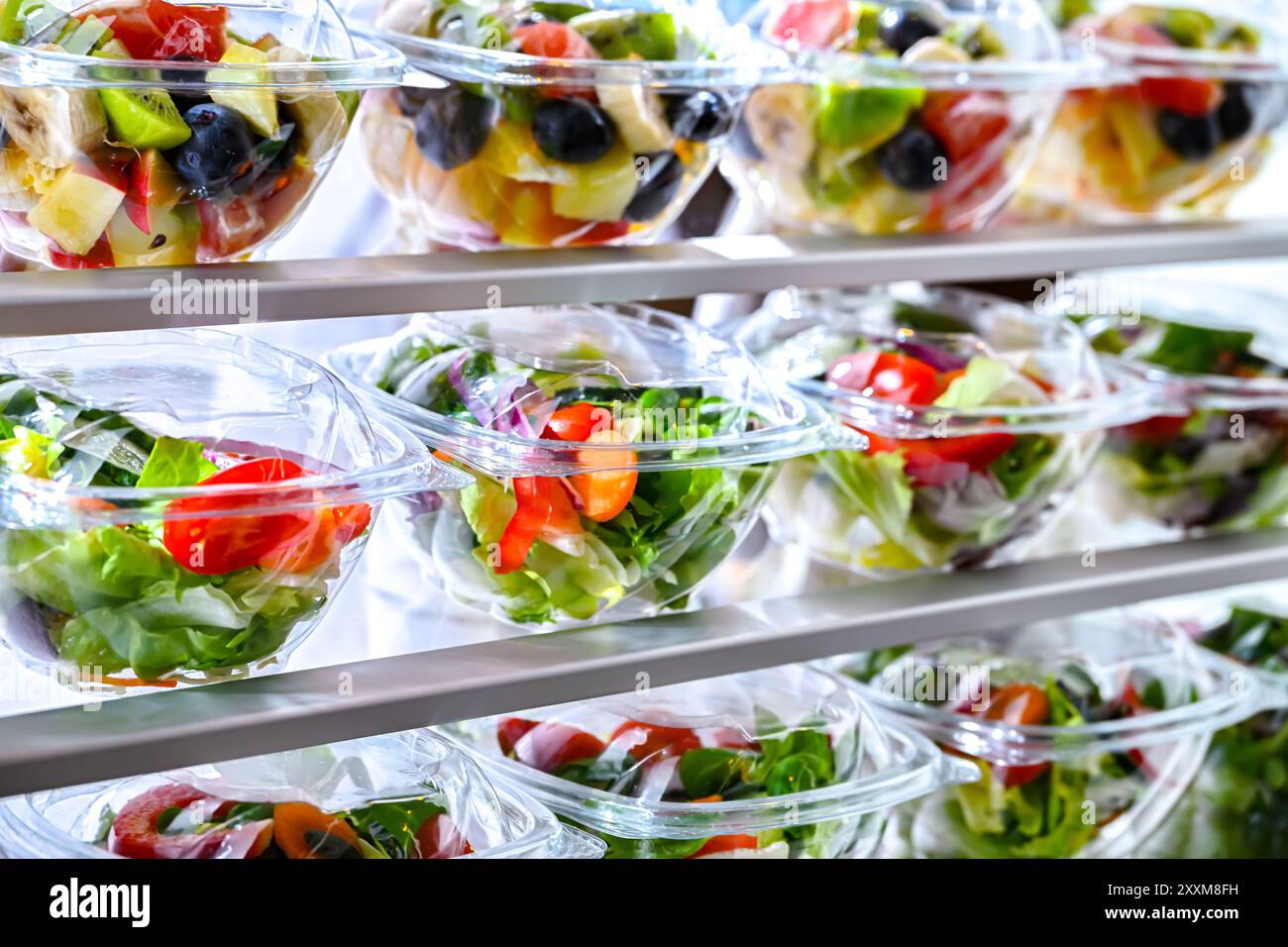 Plastic boxes with pre-packaged fruit and vegetable salads, put up for ...