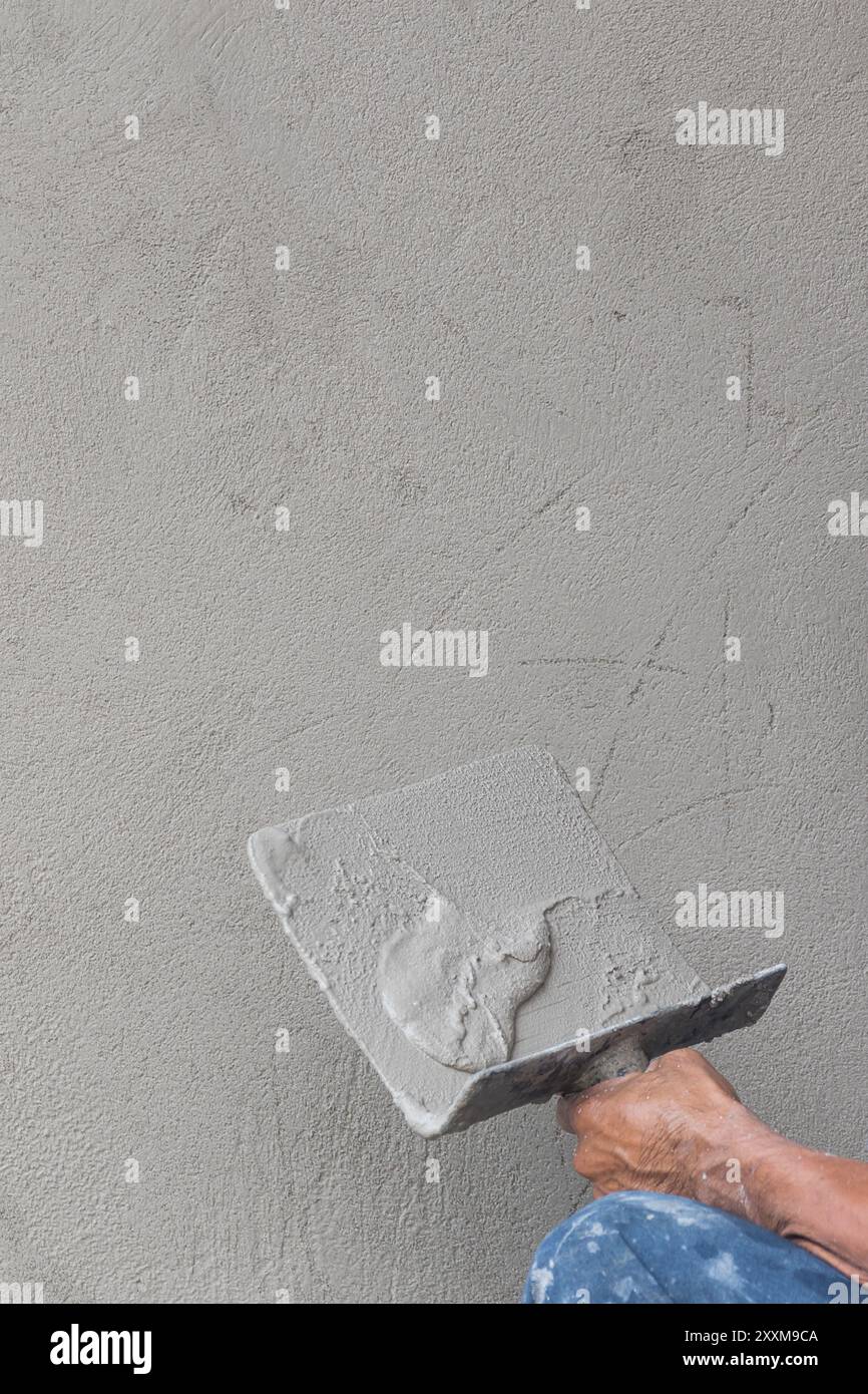 Builder worker plastering concrete at wall of house construction Stock ...