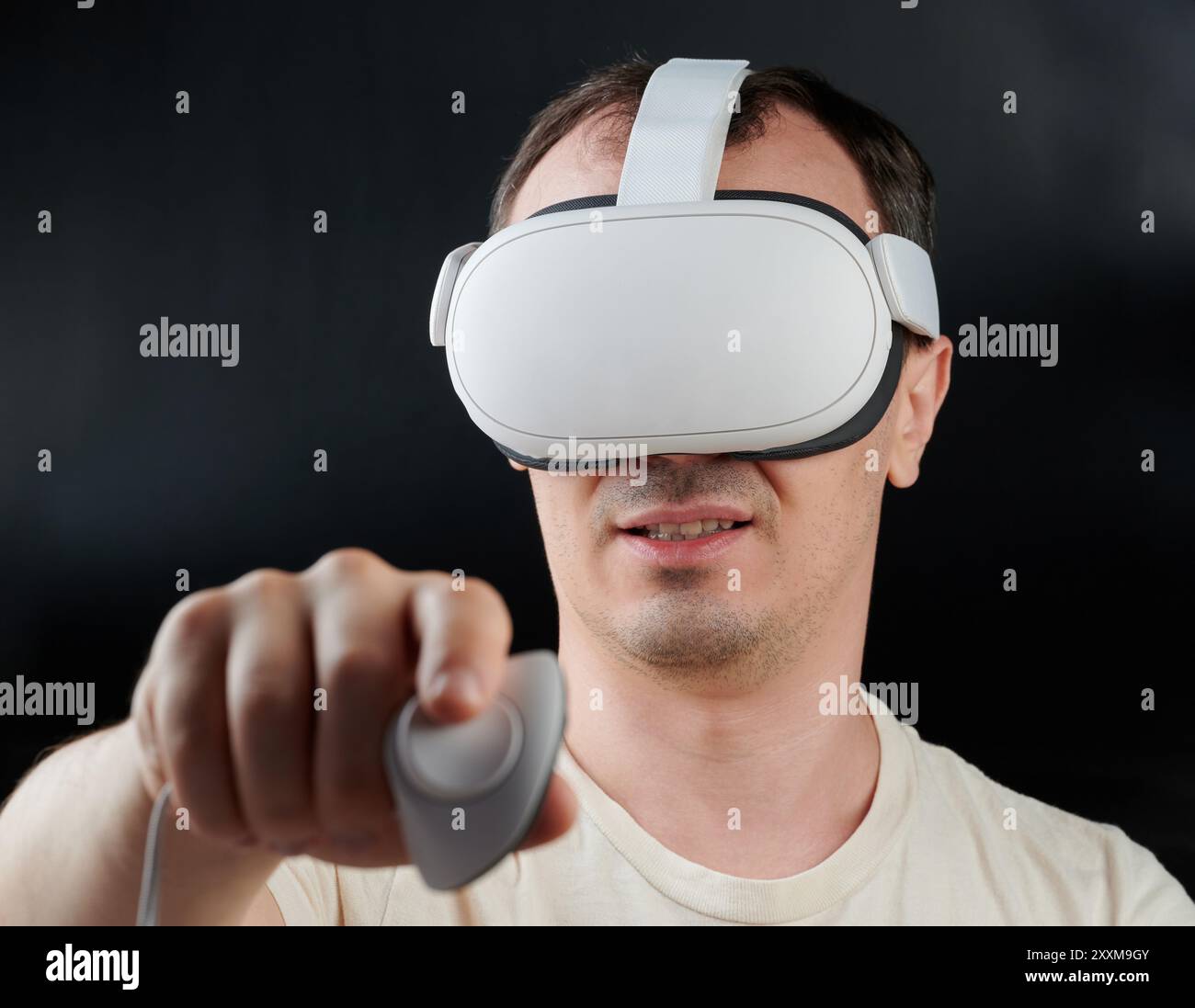 Happy man play VR games isolated on black studio background Stock Photo ...