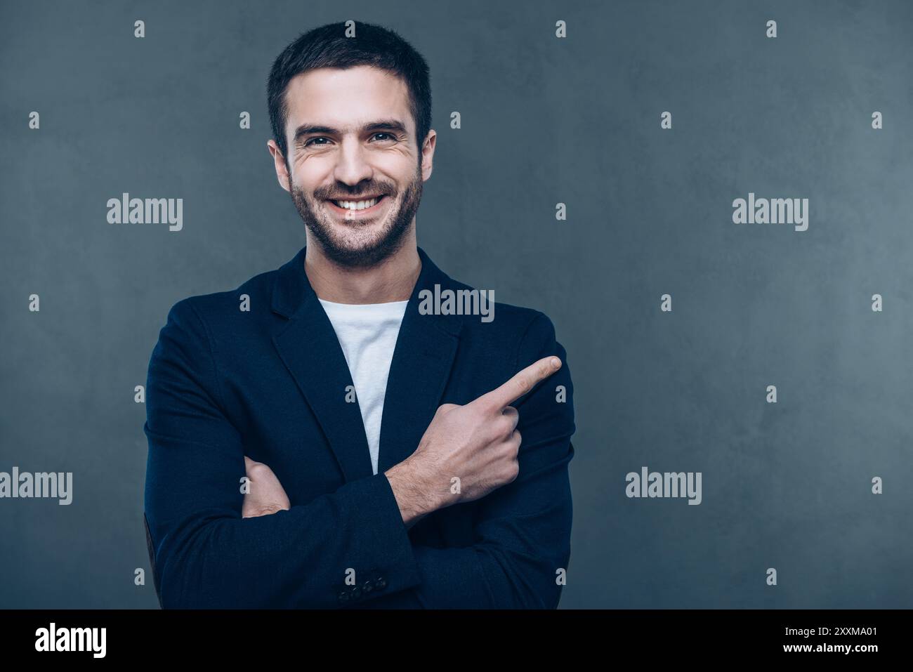 Your advertising here. Cheerful young man pointing at copy spaceand ...