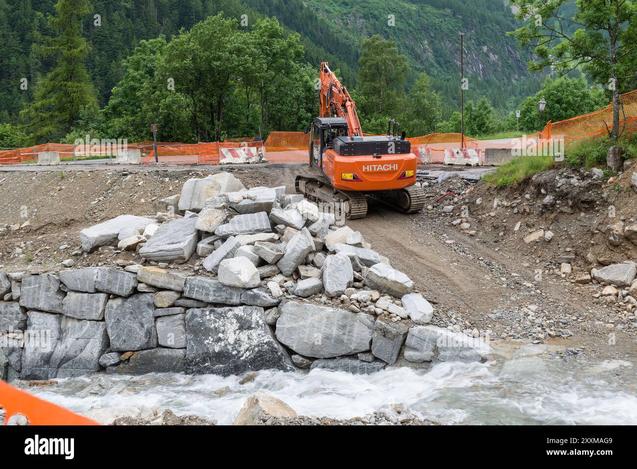 Hitachi excavator used to build a mountain creek embankment to avoid ...