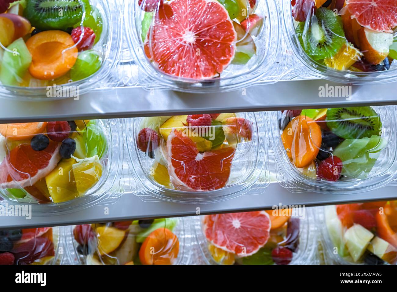 Plastic boxes with pre-packaged fruit salads, put up for sale in a ...