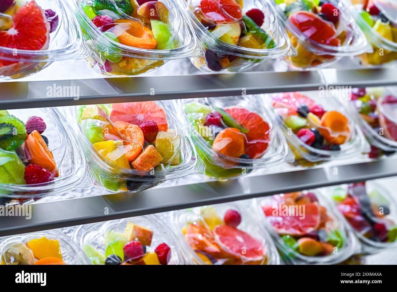 Plastic boxes with pre-packaged fruit salads, put up for sale in a ...