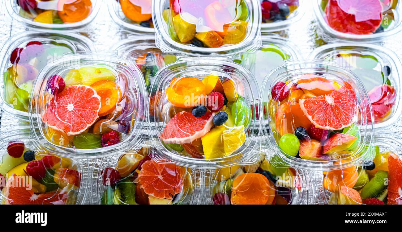 Plastic boxes with pre-packaged fruit salads, put up for sale in a ...