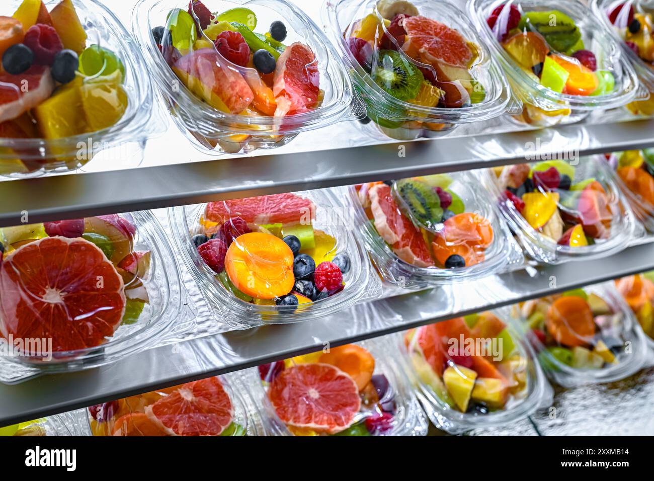 Plastic boxes with pre-packaged fruit salads, put up for sale in a ...