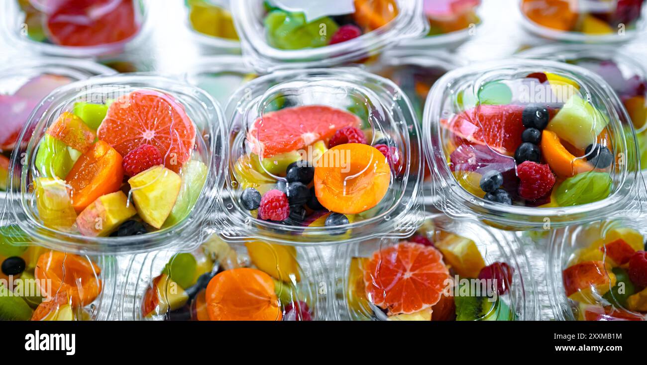 Plastic boxes with pre-packaged fruit salads, put up for sale in a ...