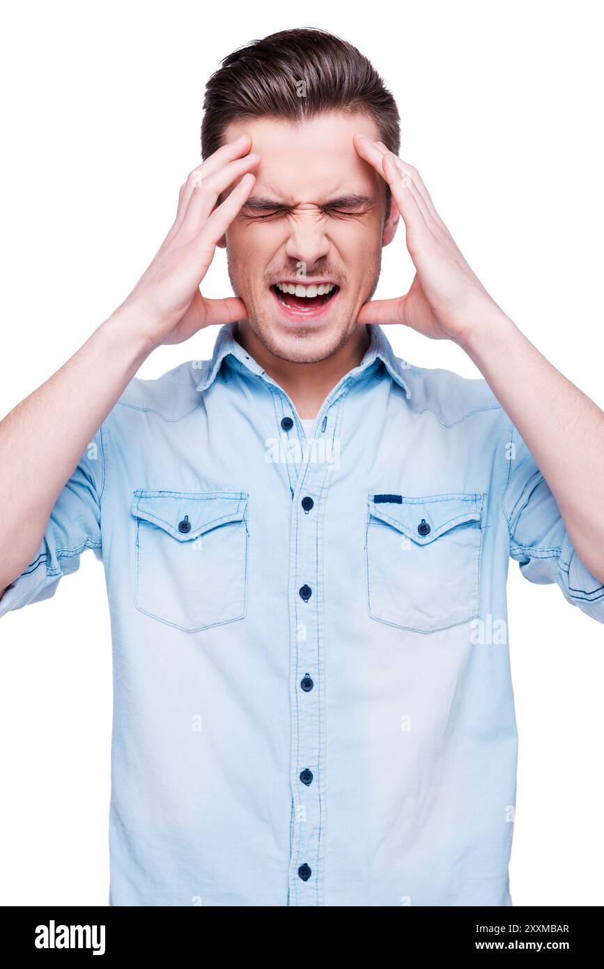 Failed again. Young man in shirt touching his head and keeping eyes ...