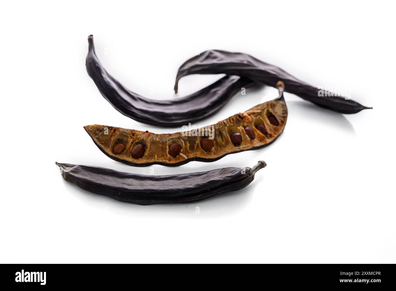 Carob carob fruit and seeds on white background Isolate Stock Photo - Alamy
