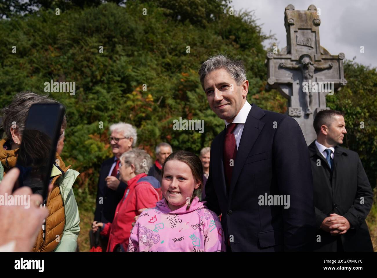 Taoiseach Simon Harris poses for a photo with Orla O'Sullivan aged 10 following a ceremony at ...