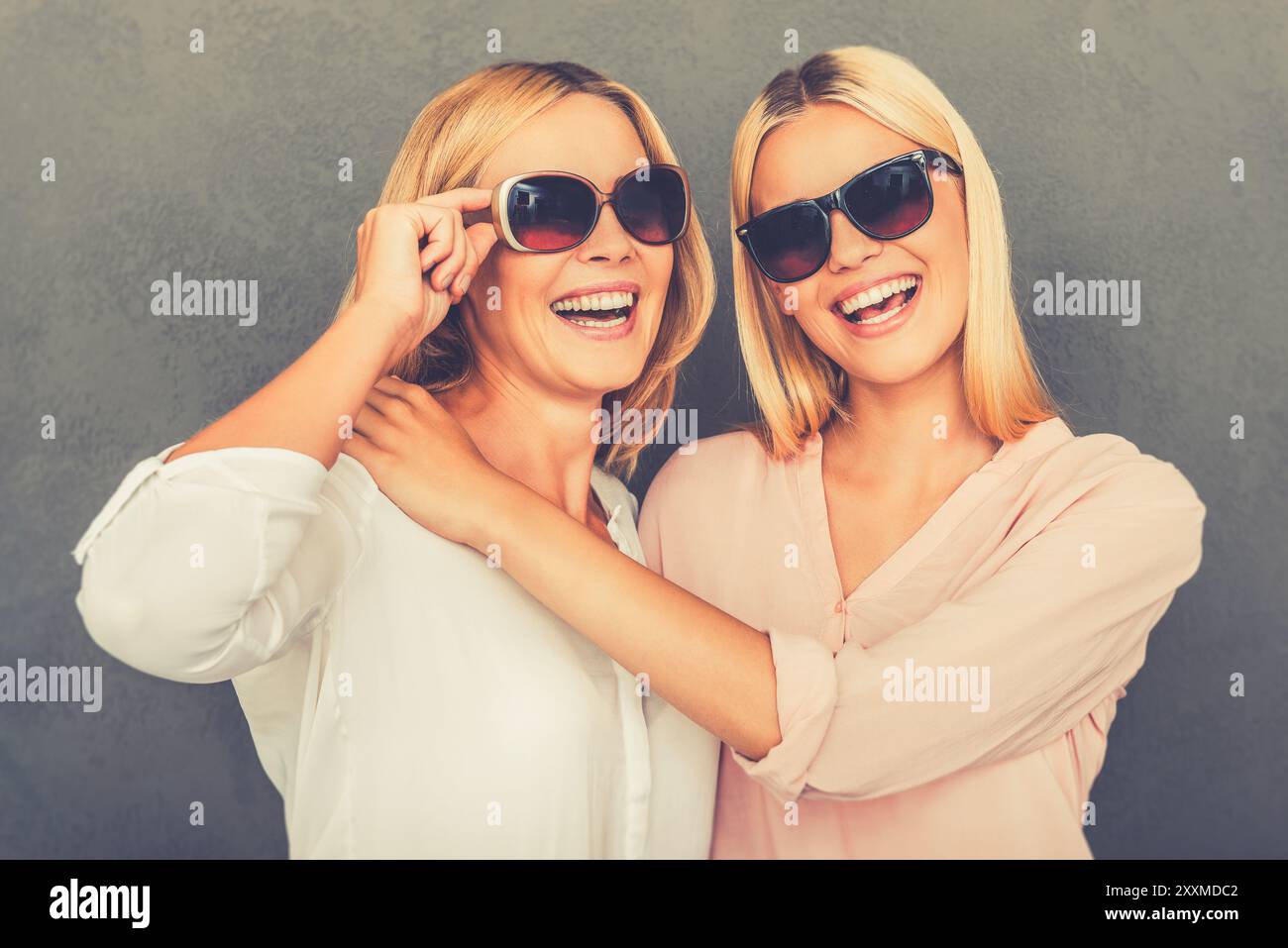 They love having fun together. Beautiful blond hair mother and daughter ...