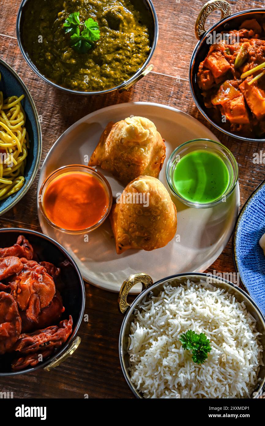Composition with indian dishes: samosa, pakora, palak paneer, jalfrezi ...